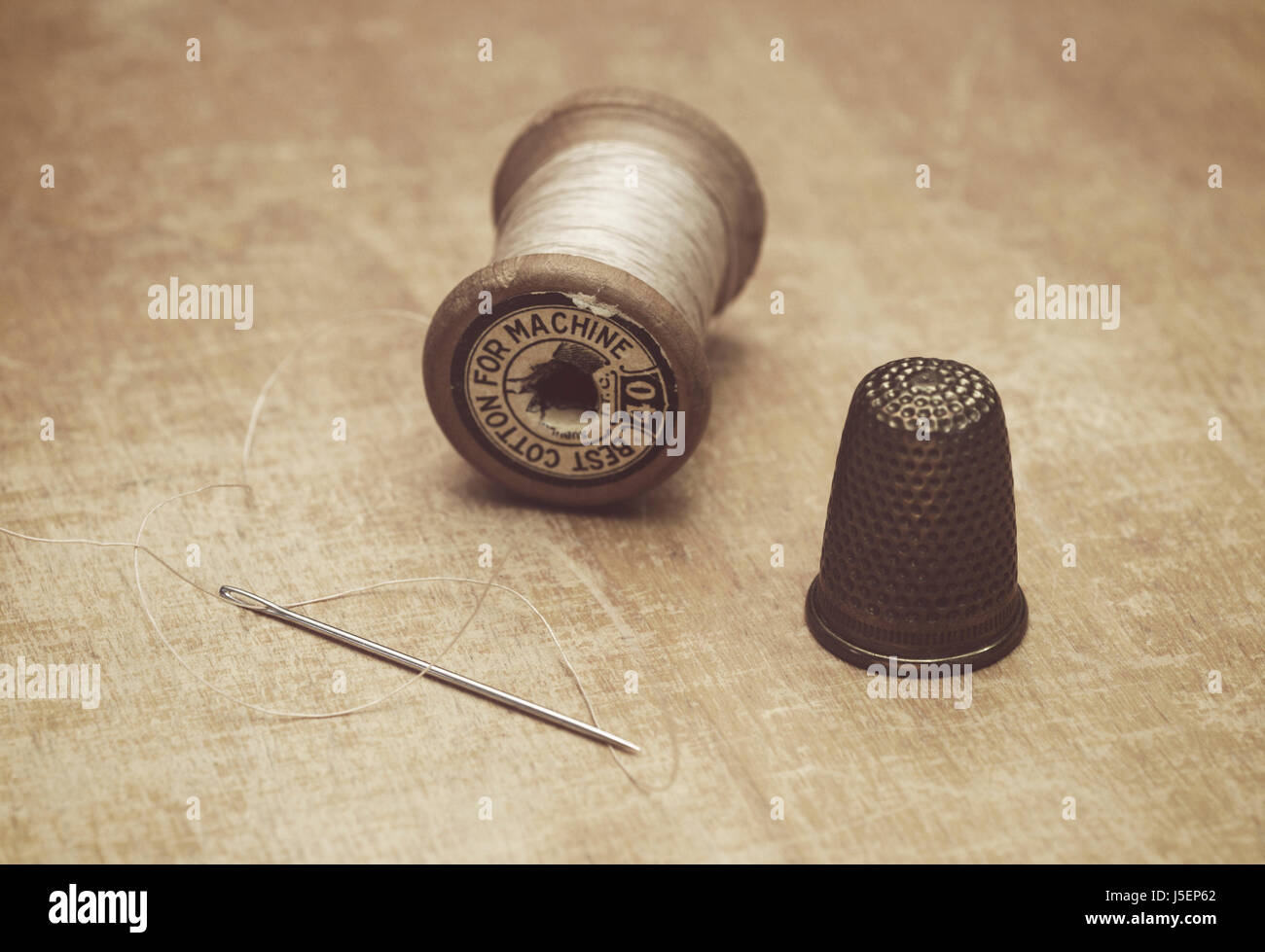 thimble, needle and spool of thread Stock Photo - Alamy