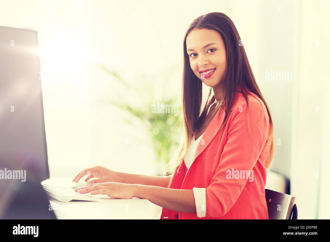 happy african woman with computer at office Stock Photo - Alamy