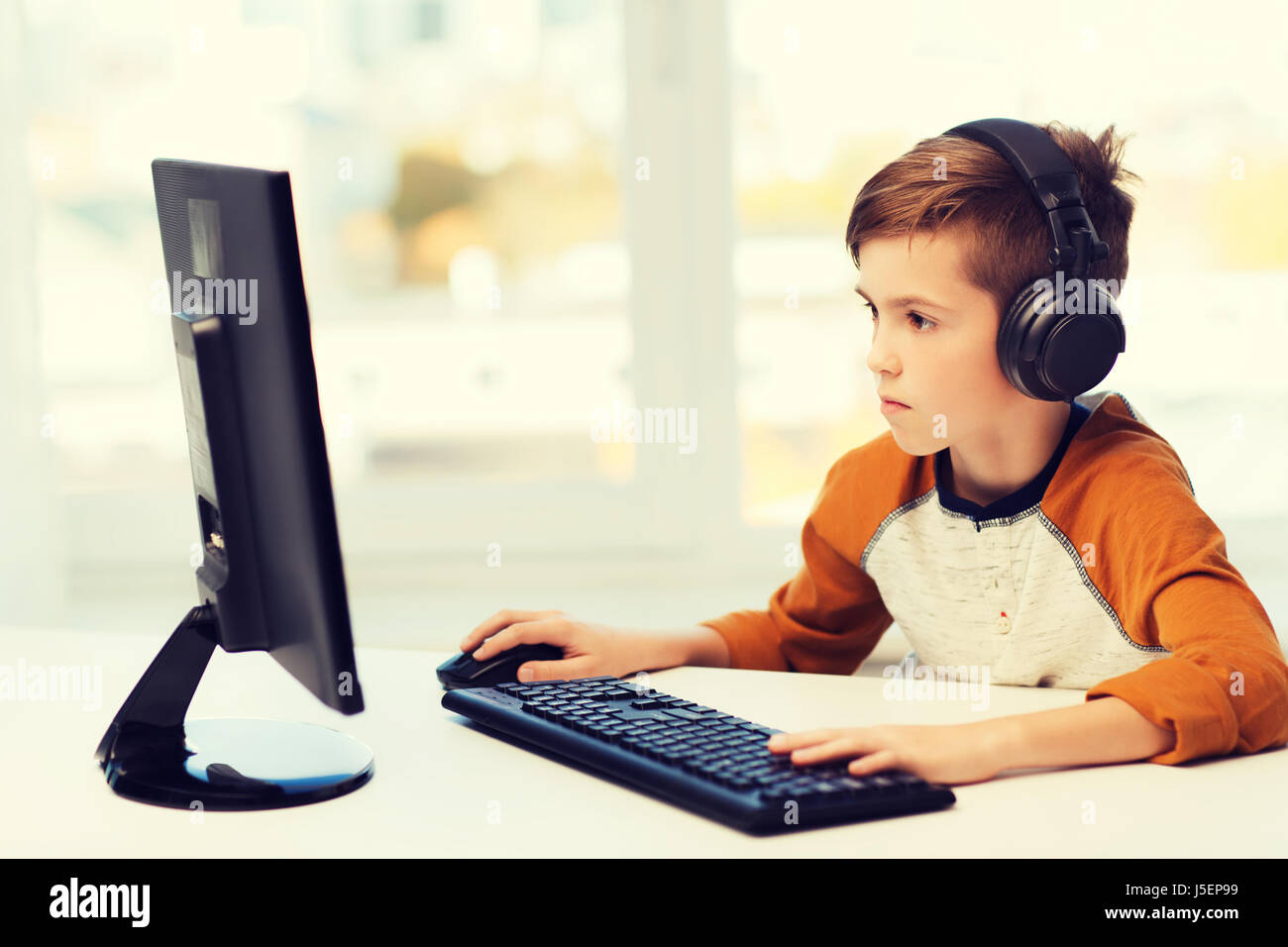 boy with computer and headphones at home Stock Photo - Alamy