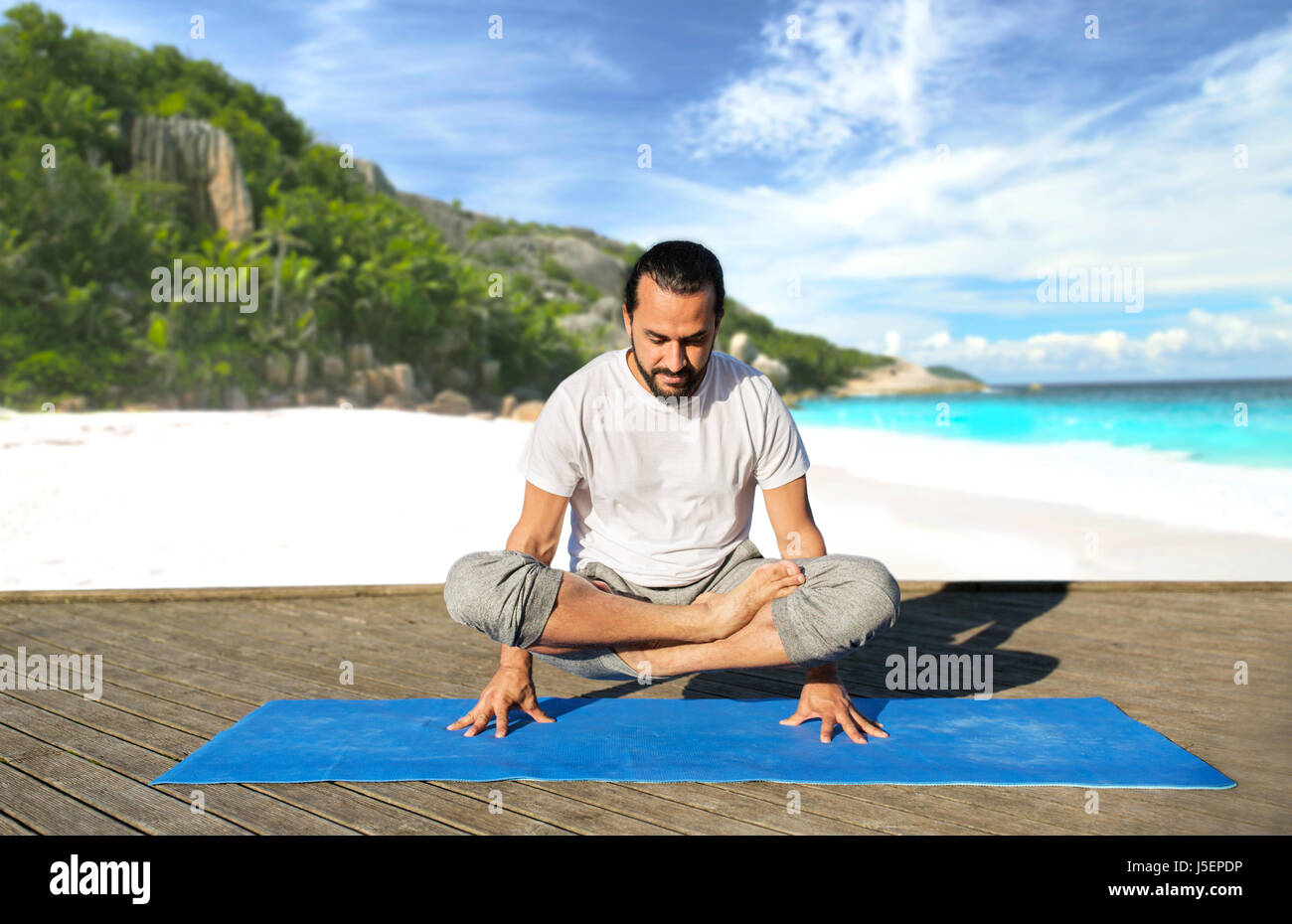 man making yoga in scale pose outdoors Stock Photo - Alamy