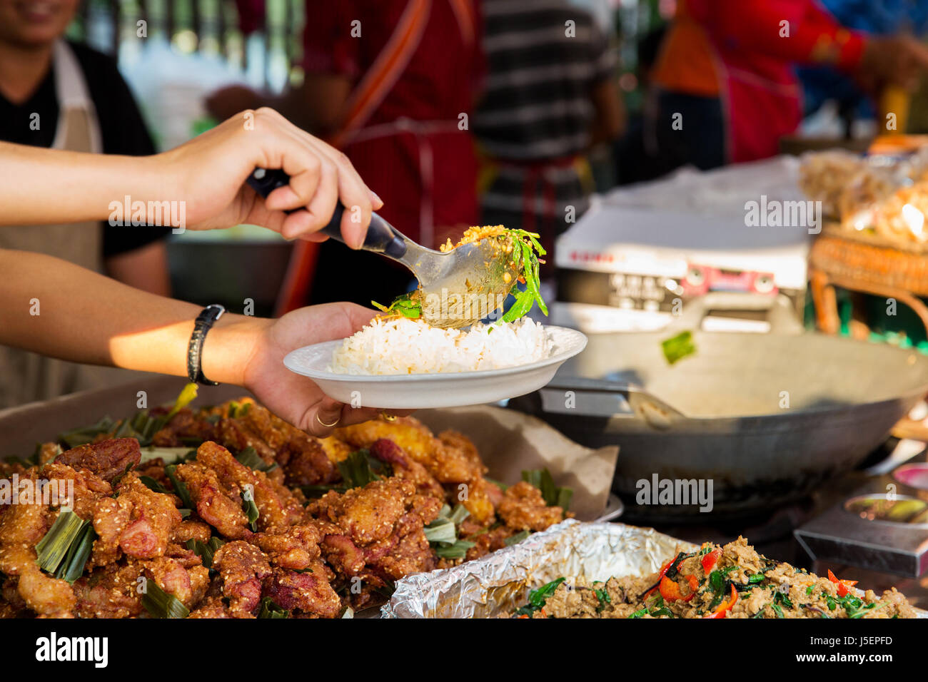 Rice eating hand street hi-res stock photography and images - Alamy