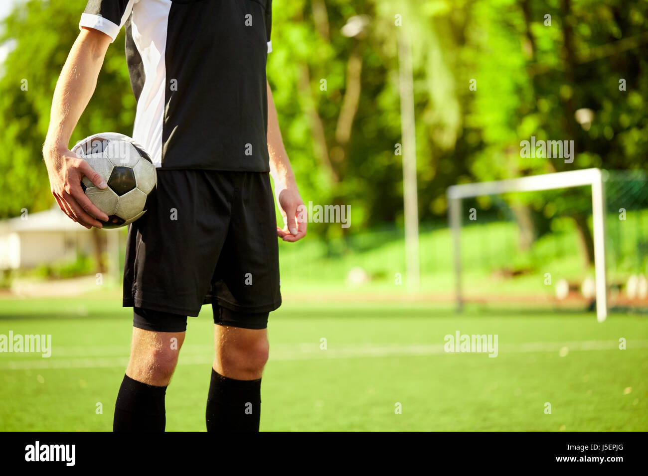 soccer player with ball on football field Stock Photo - Alamy