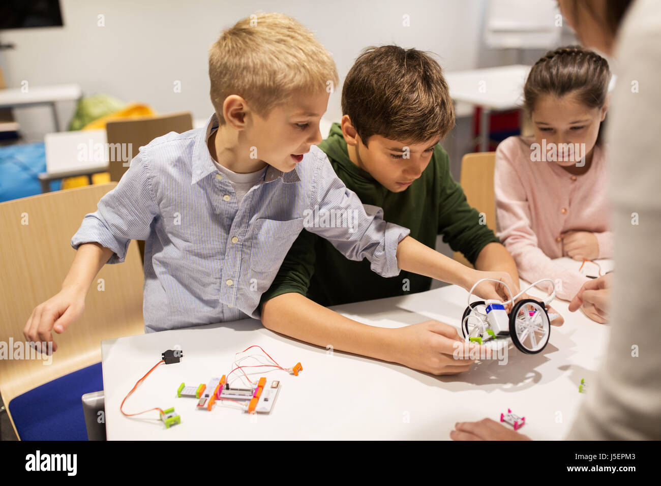 happy children building robots at robotics school Stock Photo - Alamy