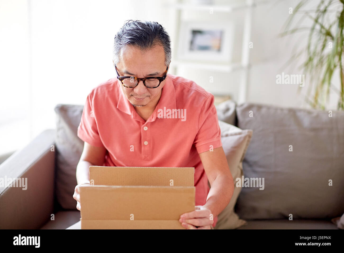 man opening parcel box at home Stock Photo - Alamy