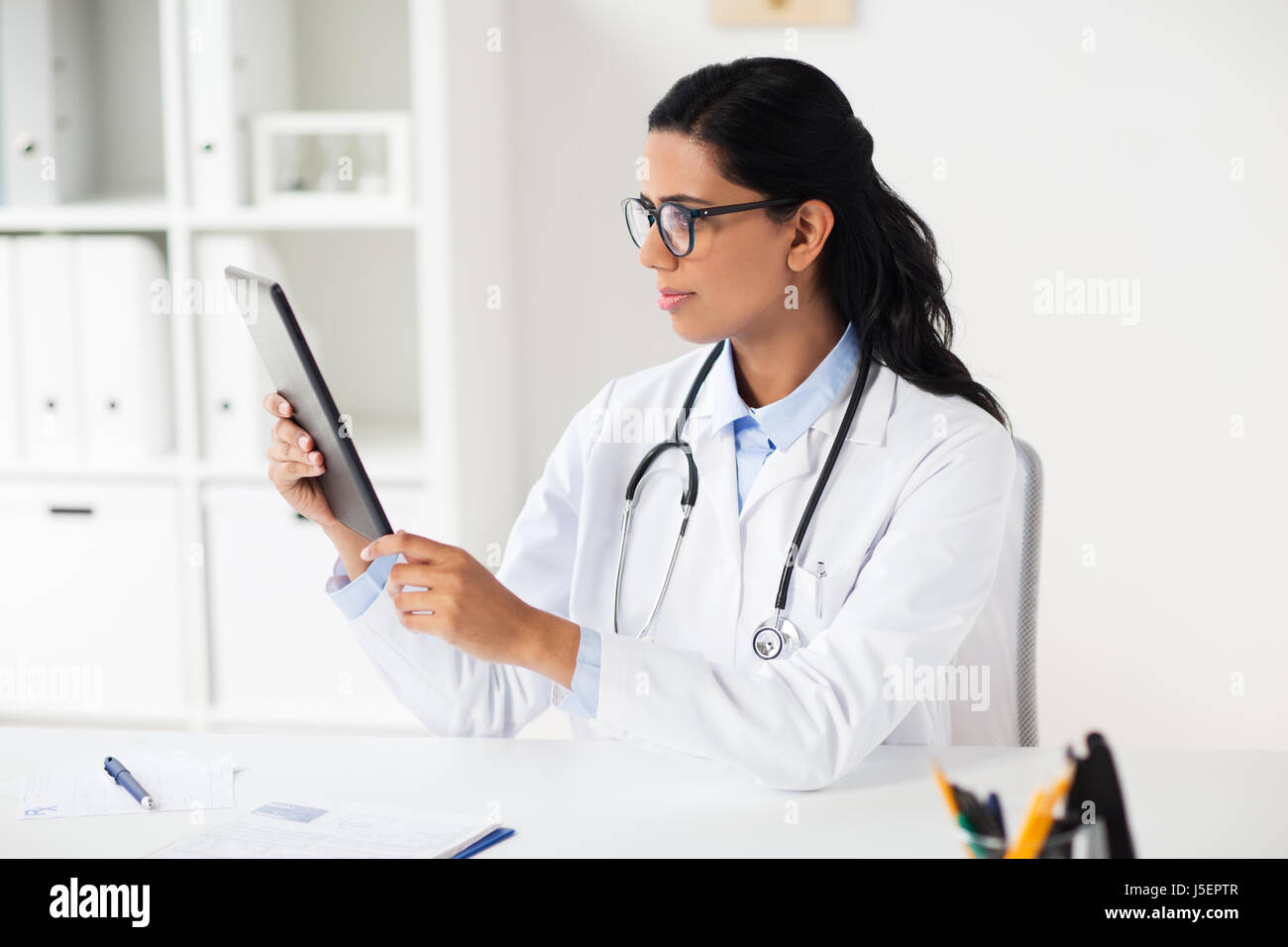doctor with tablet pc and clipboard at hospital Stock Photo - Alamy