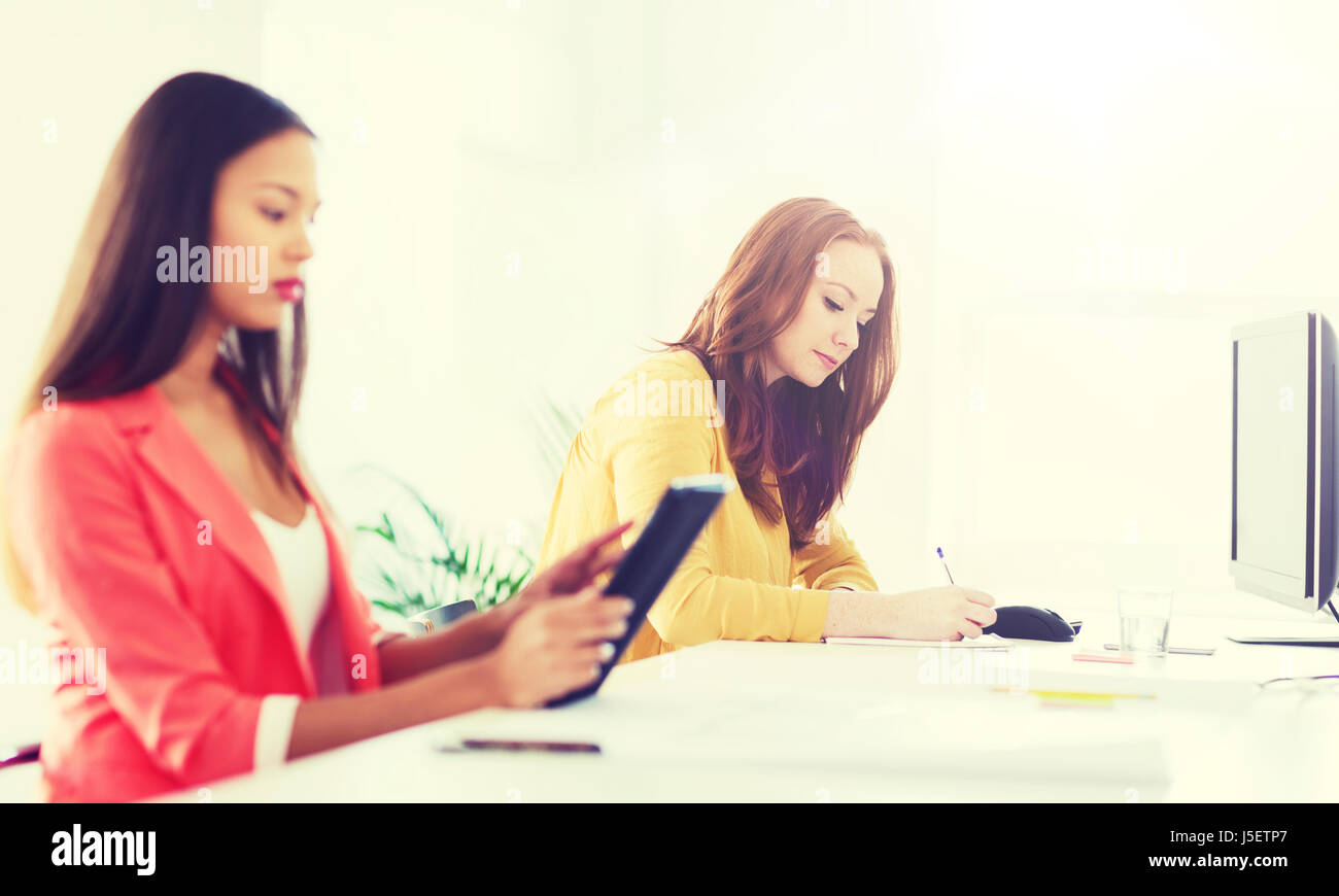 creative female office worker writing to notebook Stock Photo - Alamy
