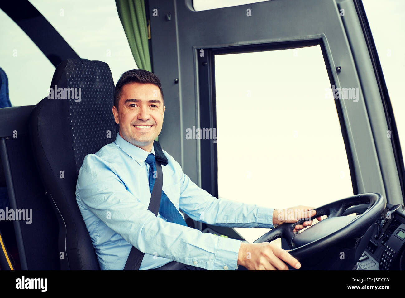 happy driver driving intercity bus Stock Photo - Alamy