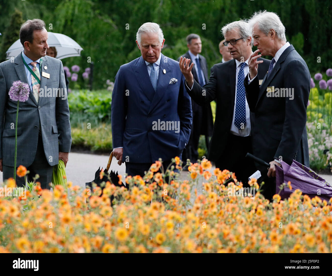 The Prince of Wales (centre) views a display planted in the Great Broad ...