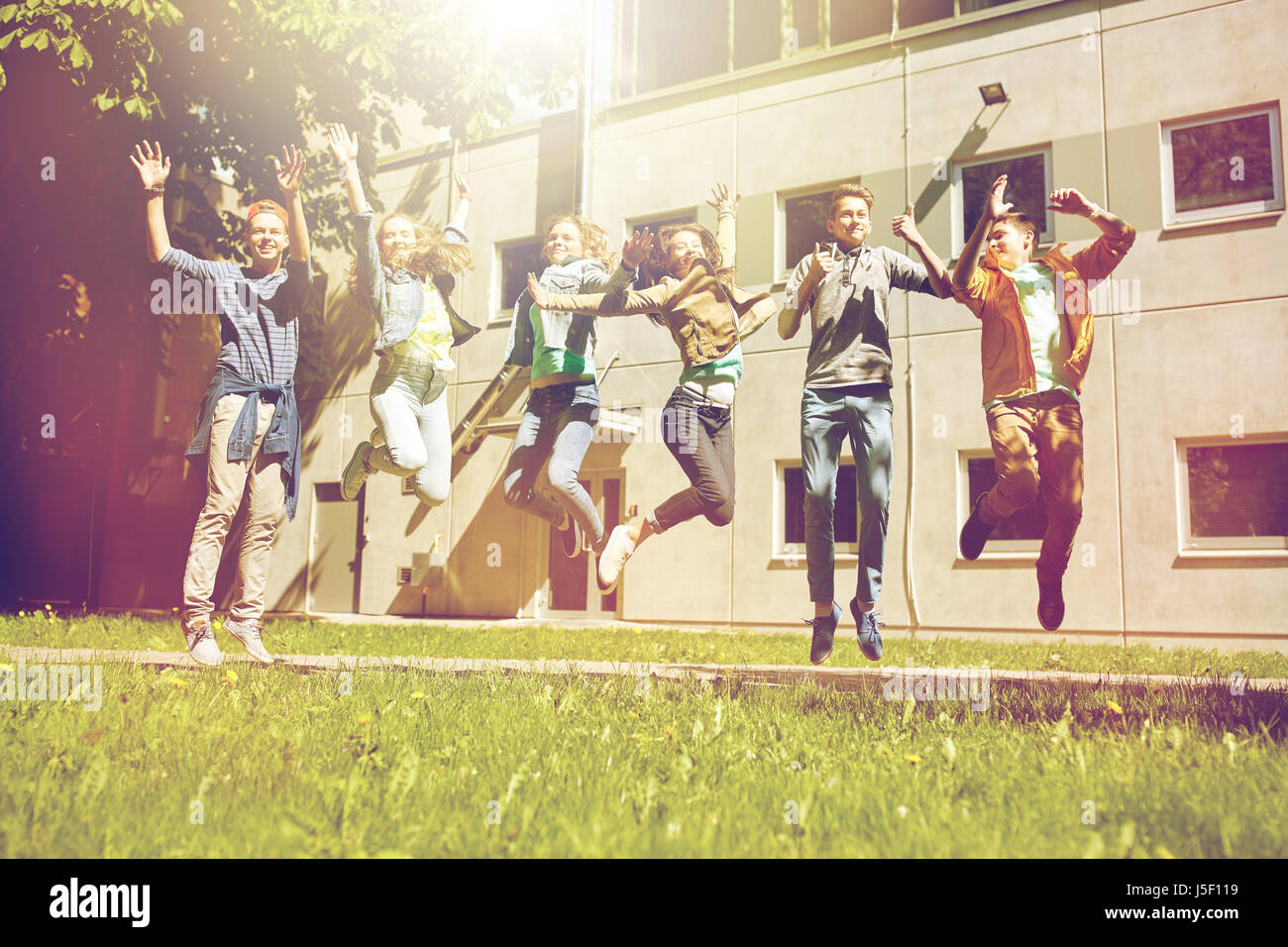 happy teenage students or friends jumping outdoors Stock Photo - Alamy
