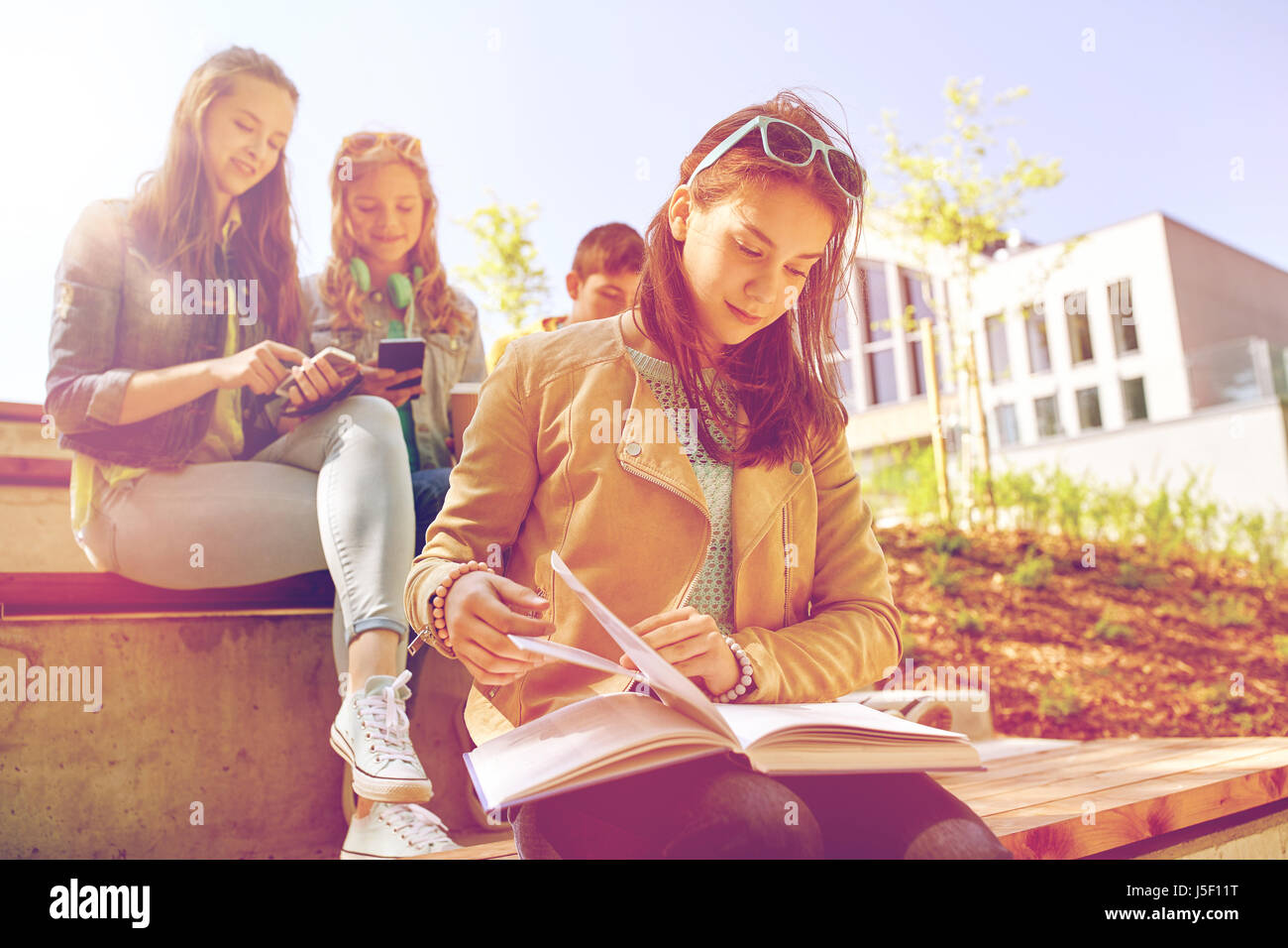 high school student girl reading book outdoors Stock Photo - Alamy