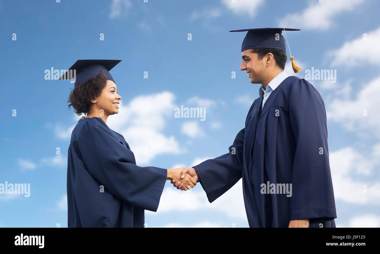 happy students or bachelors greeting each other Stock Photo - Alamy