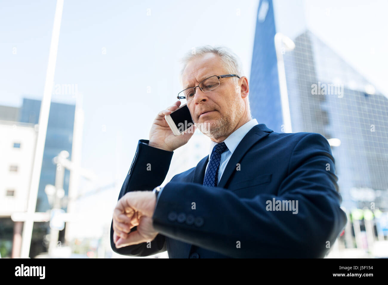 senior businessman calling on smartphone in city Stock Photo - Alamy