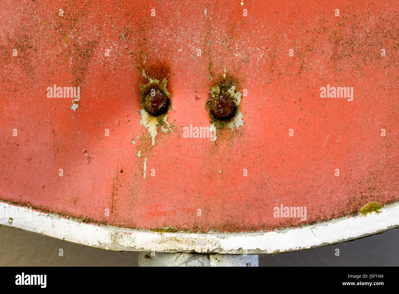 No Entry sign showing signs of fading and damage. Two retaining ...