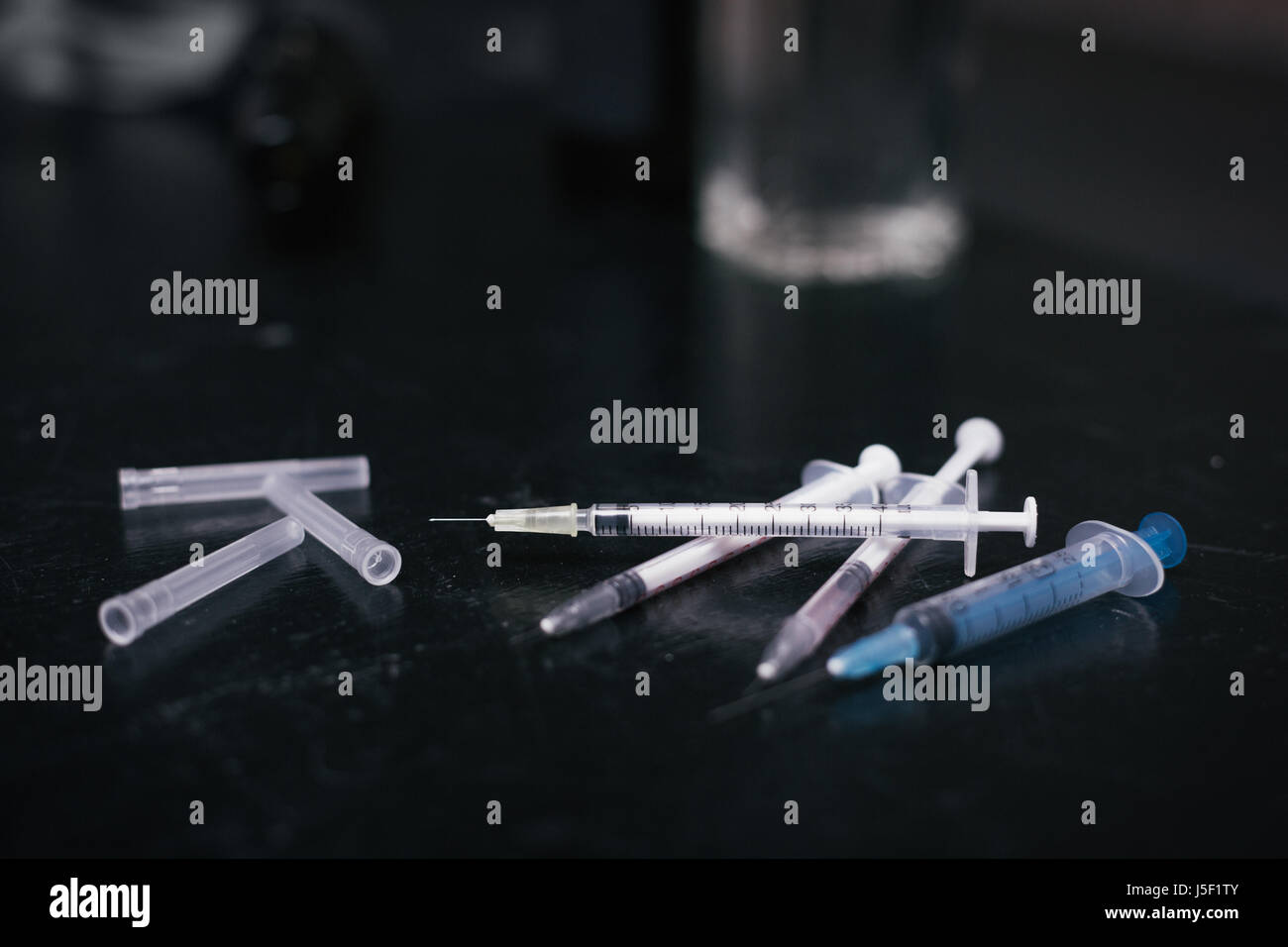 Infected syringes lying in the drug den Stock Photo - Alamy