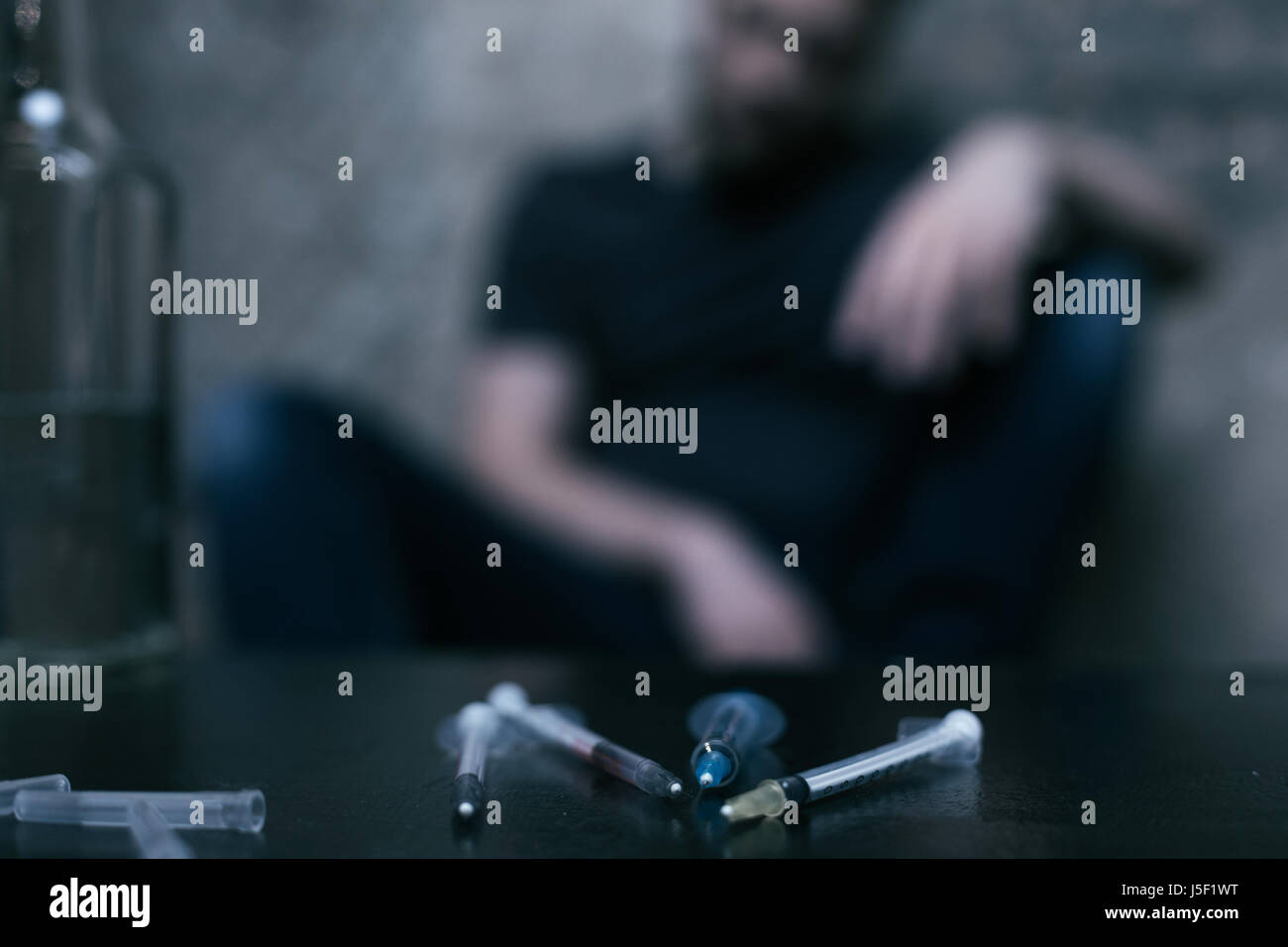 Infected syringes lying on the table in the darkness Stock Photo - Alamy