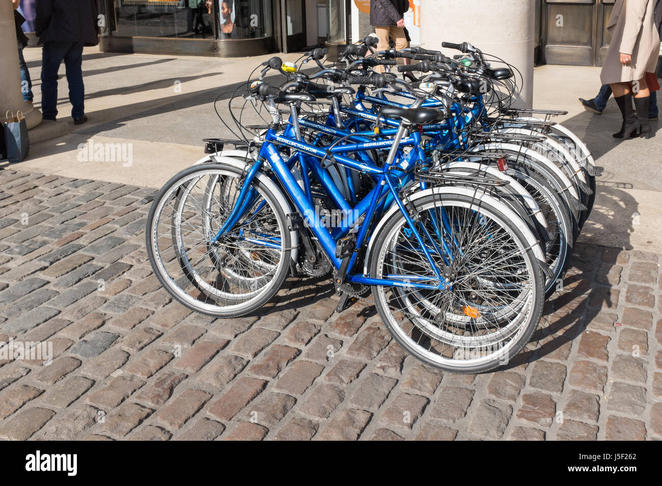 Six matching blue hire bicycles attached together in Covent Garden ...