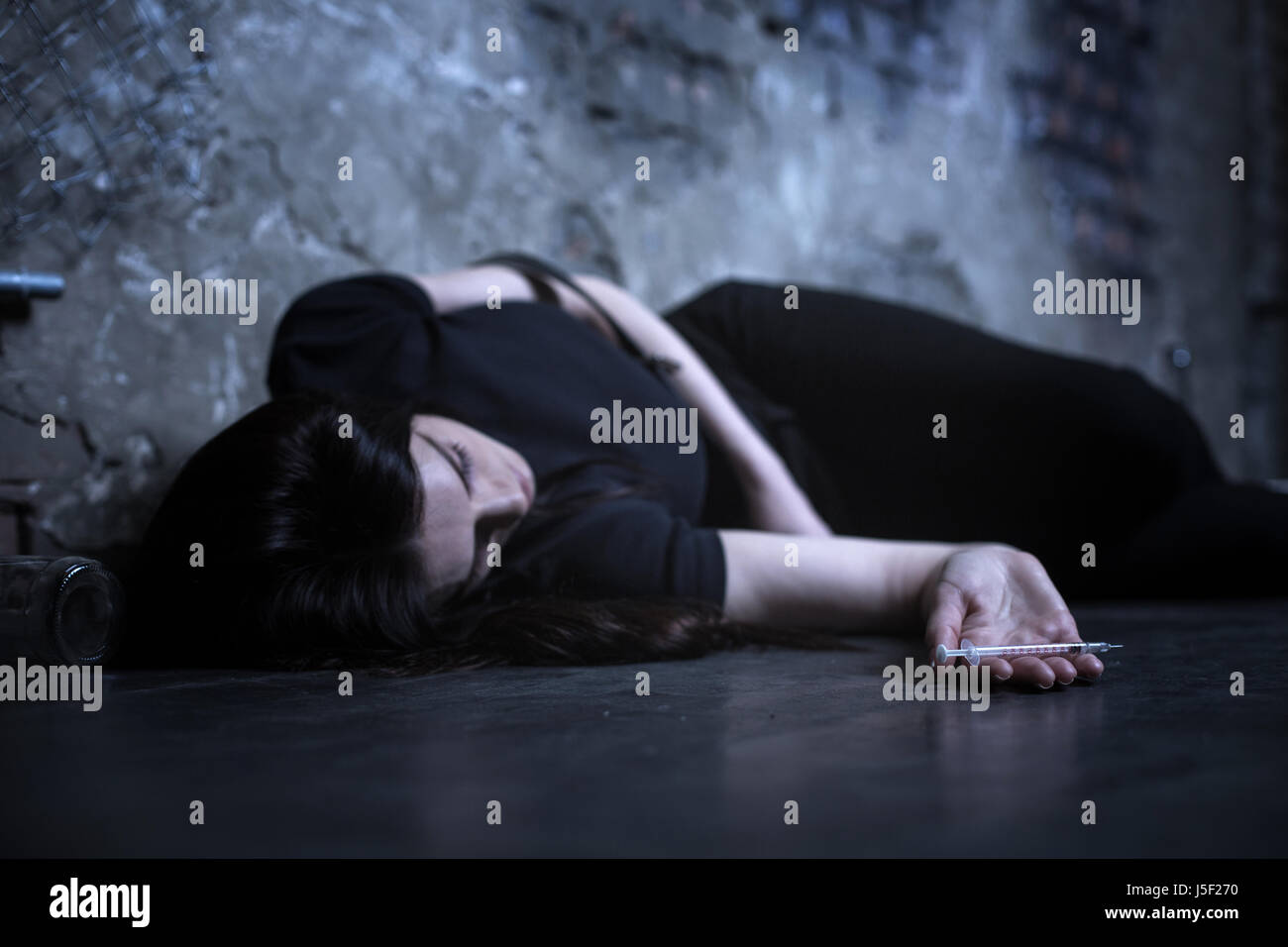 Dead junky lying on the ground outdoors Stock Photo - Alamy