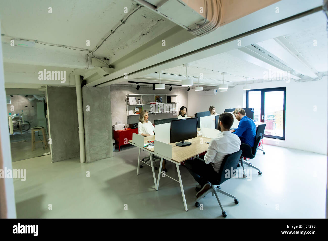 Young programmers sit and work in a modern office Stock Photo - Alamy