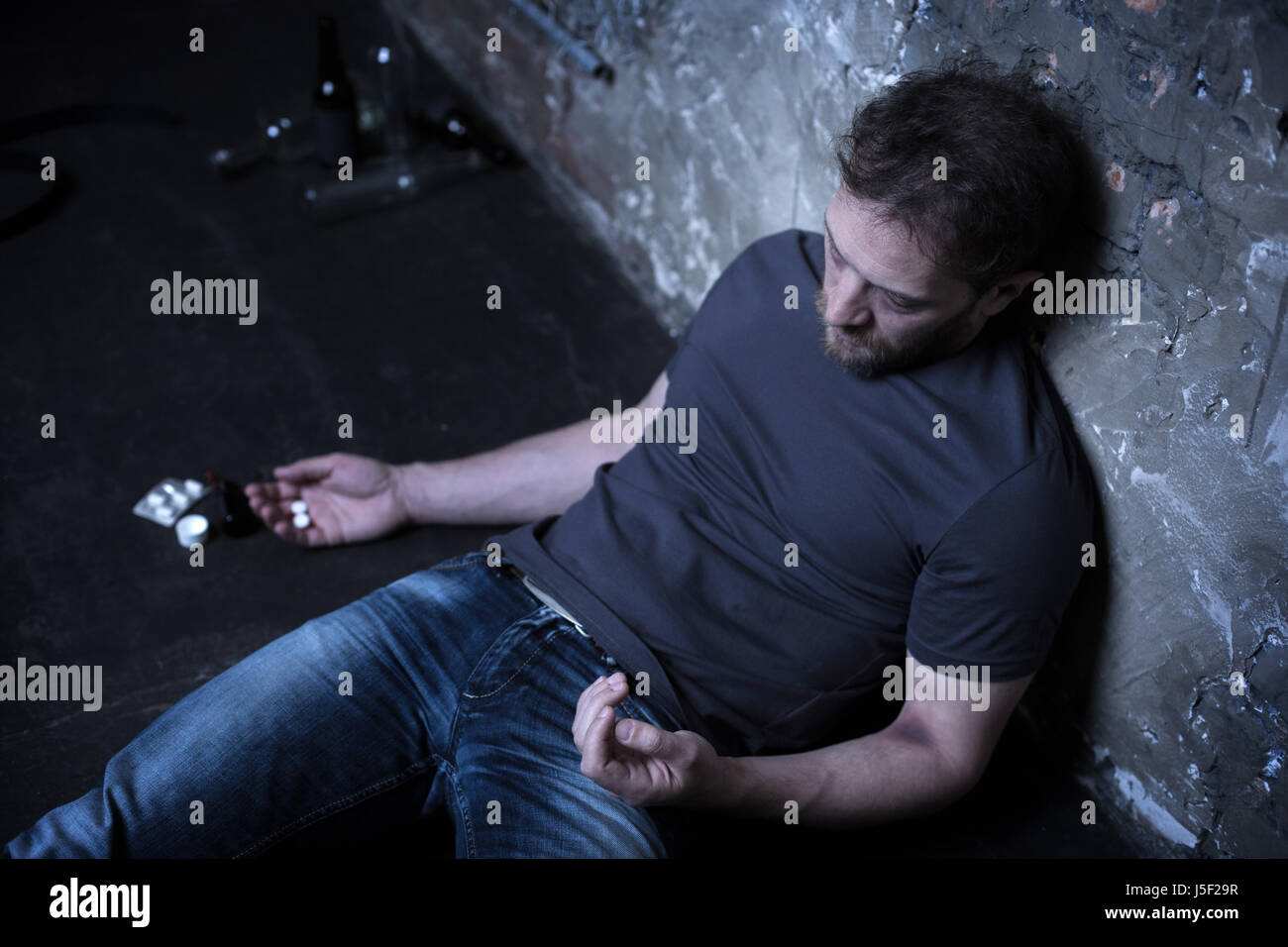 Heavy drug user suffering from overdose in the darkness Stock Photo - Alamy