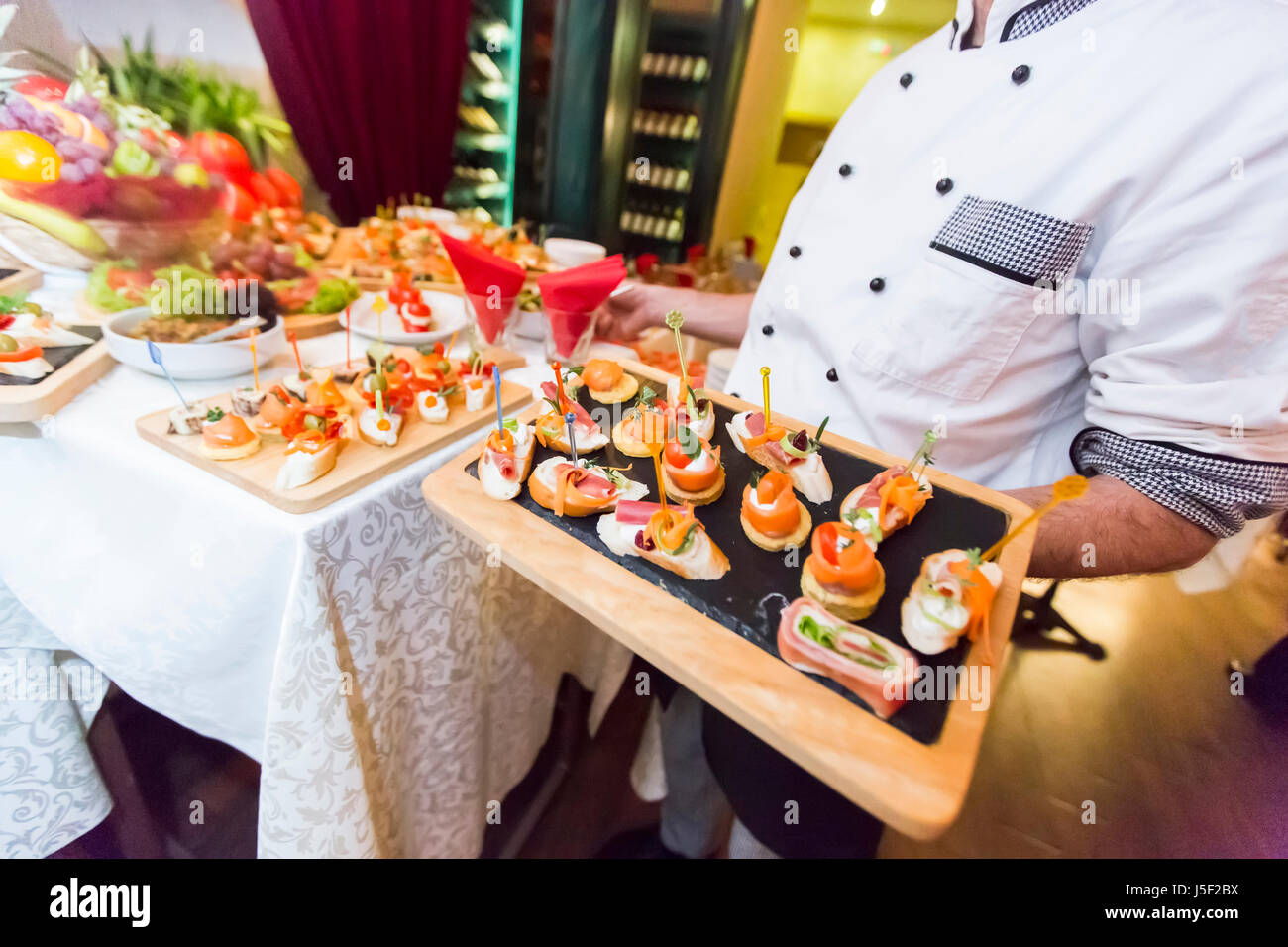 View at chef serving food in restaurant Stock Photo - Alamy