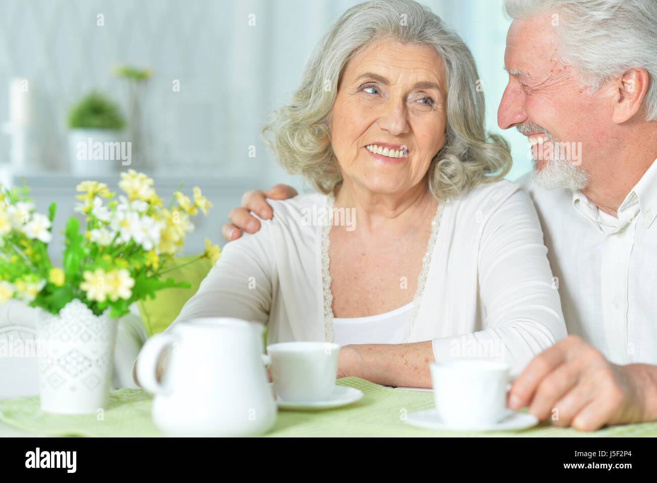 Beautiful elderly couple drinking tea Stock Photo - Alamy