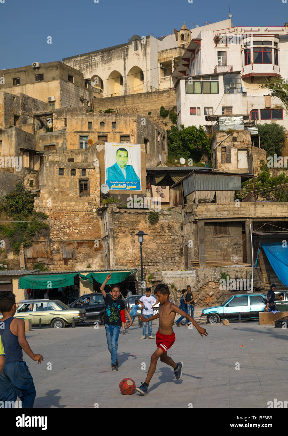 Syrian refugees children playing football in front of residential ...