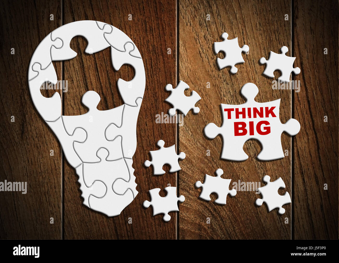 Think big concept, light bulb from puzzle Stock Photo - Alamy