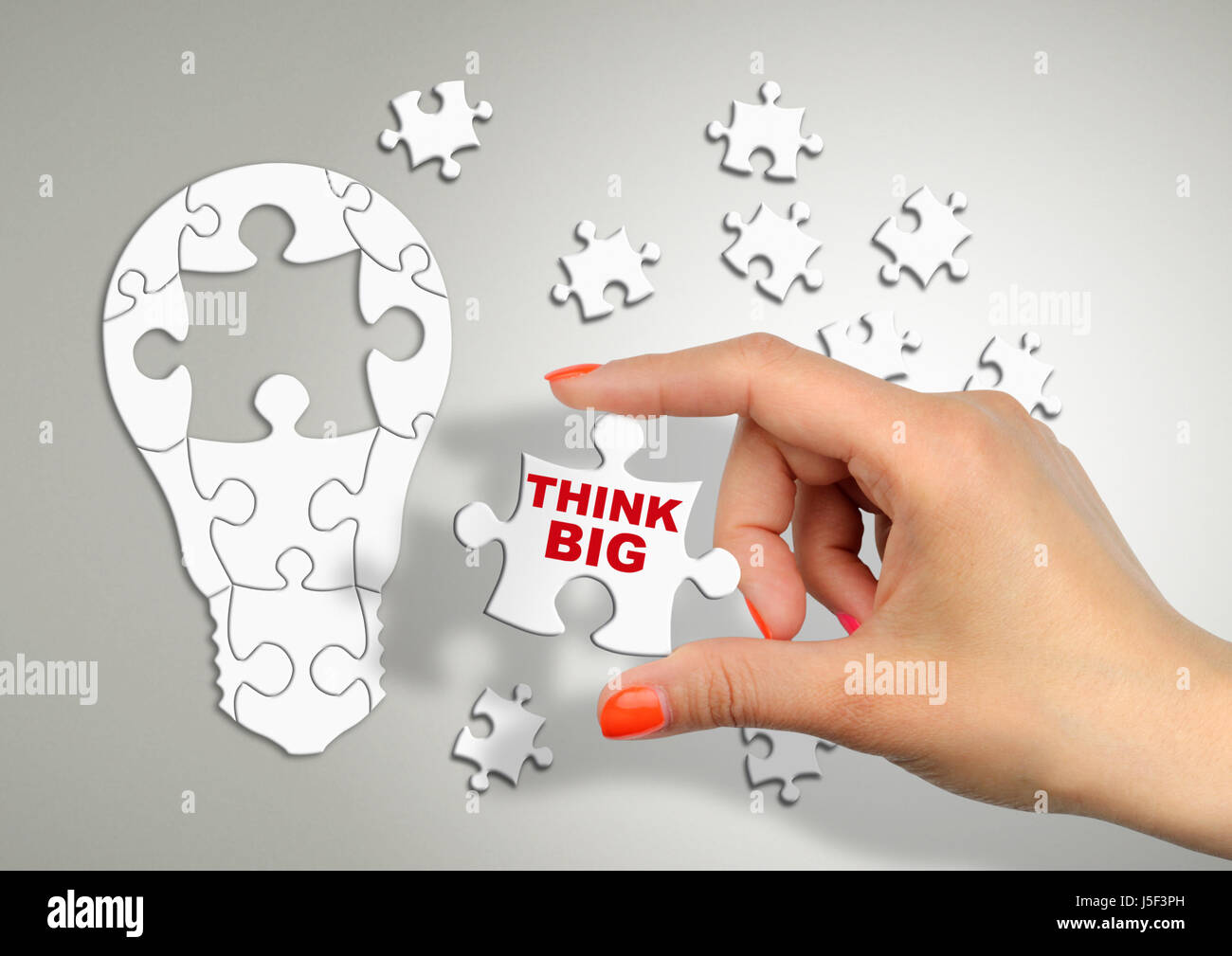 Think big concept, hand fold light bulb puzzle Stock Photo - Alamy