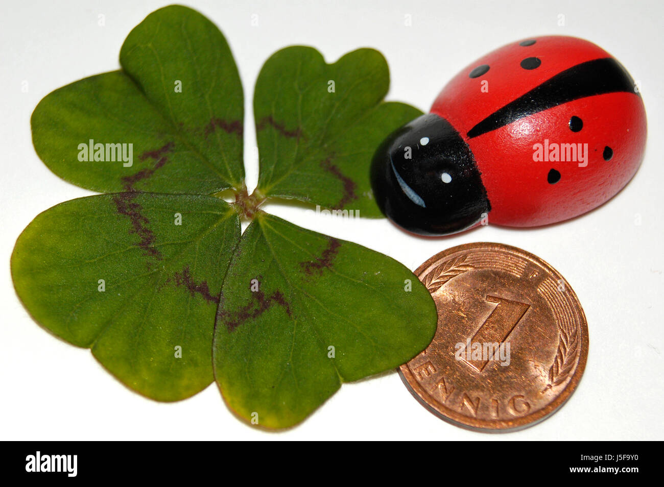 three lucky charm on white Stock Photo - Alamy