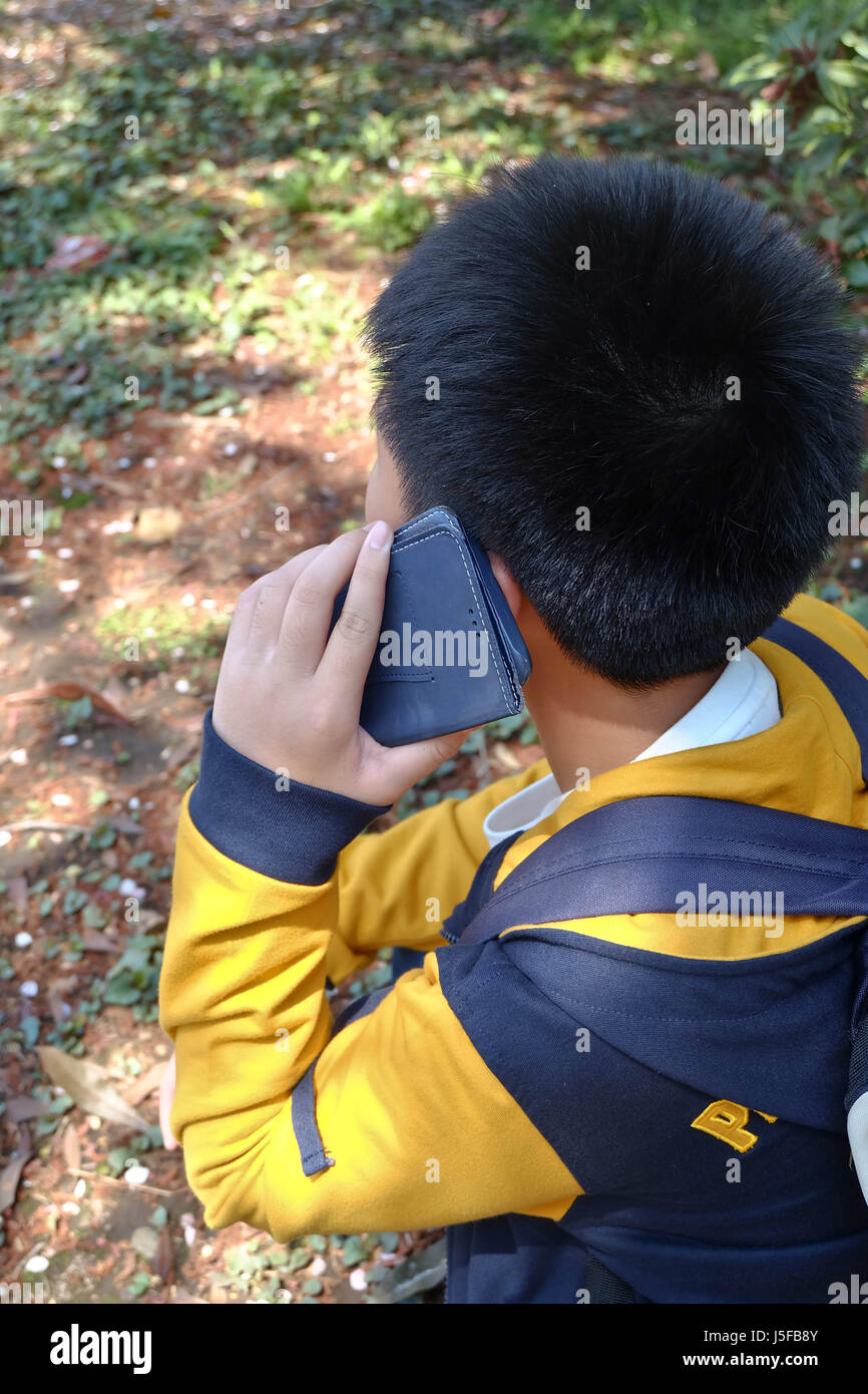a boy talking by smartphone Stock Photo - Alamy