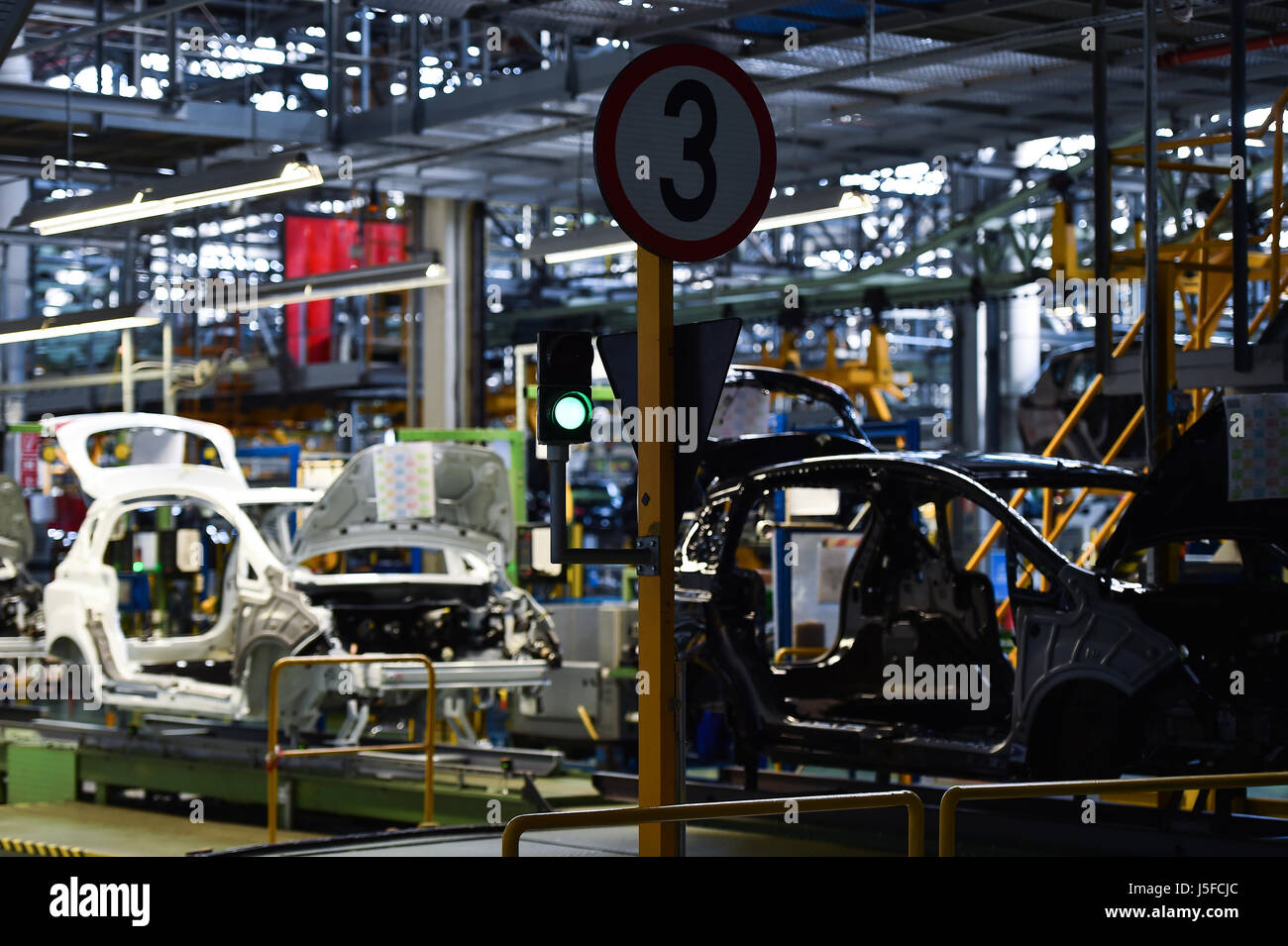 Car bodies on the production line inside automobile factory Stock Photo ...