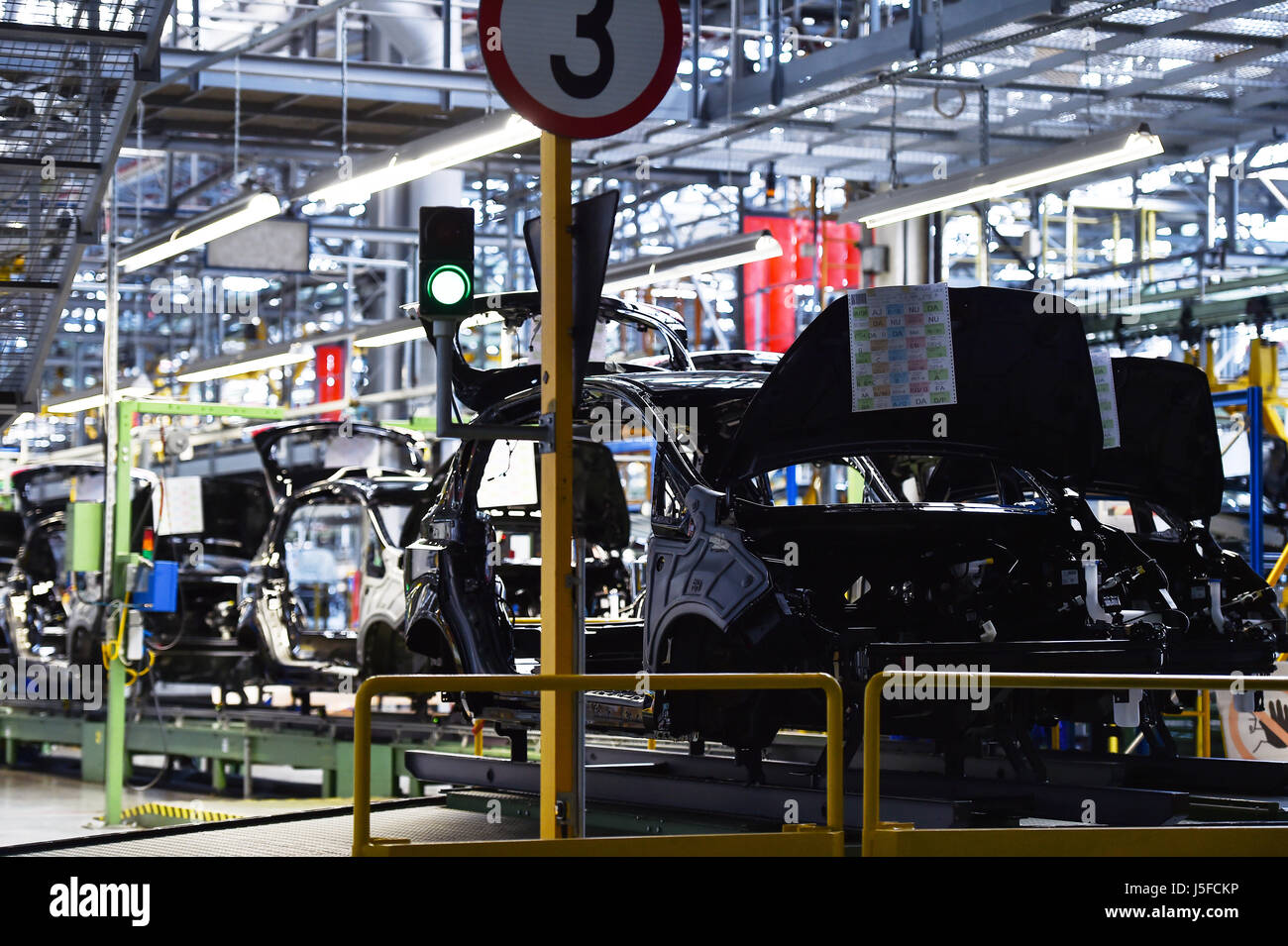 Car bodies on the production line inside automobile factory Stock Photo ...