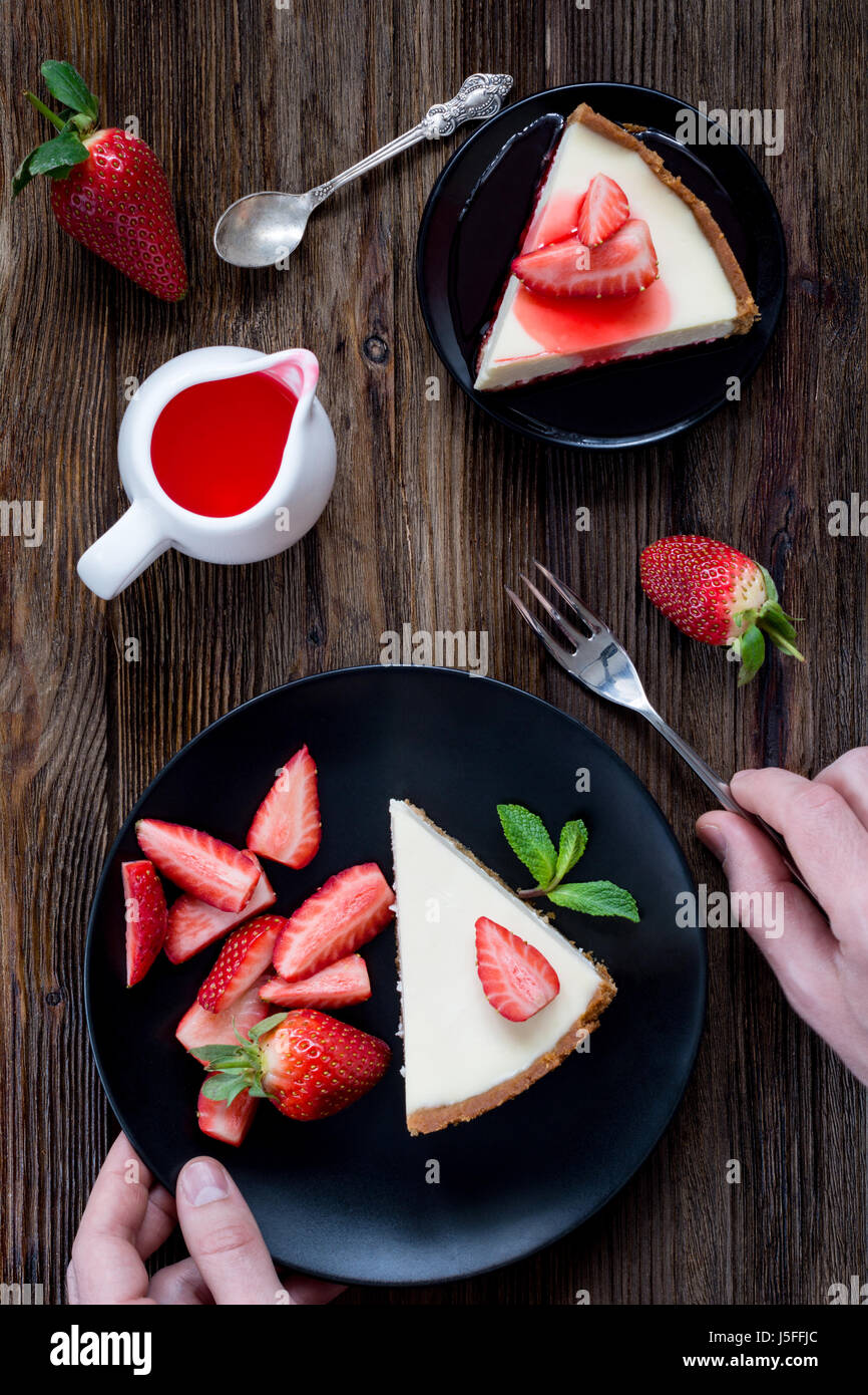 Strawberry cheesecake on black plate table top view Stock Photo - Alamy