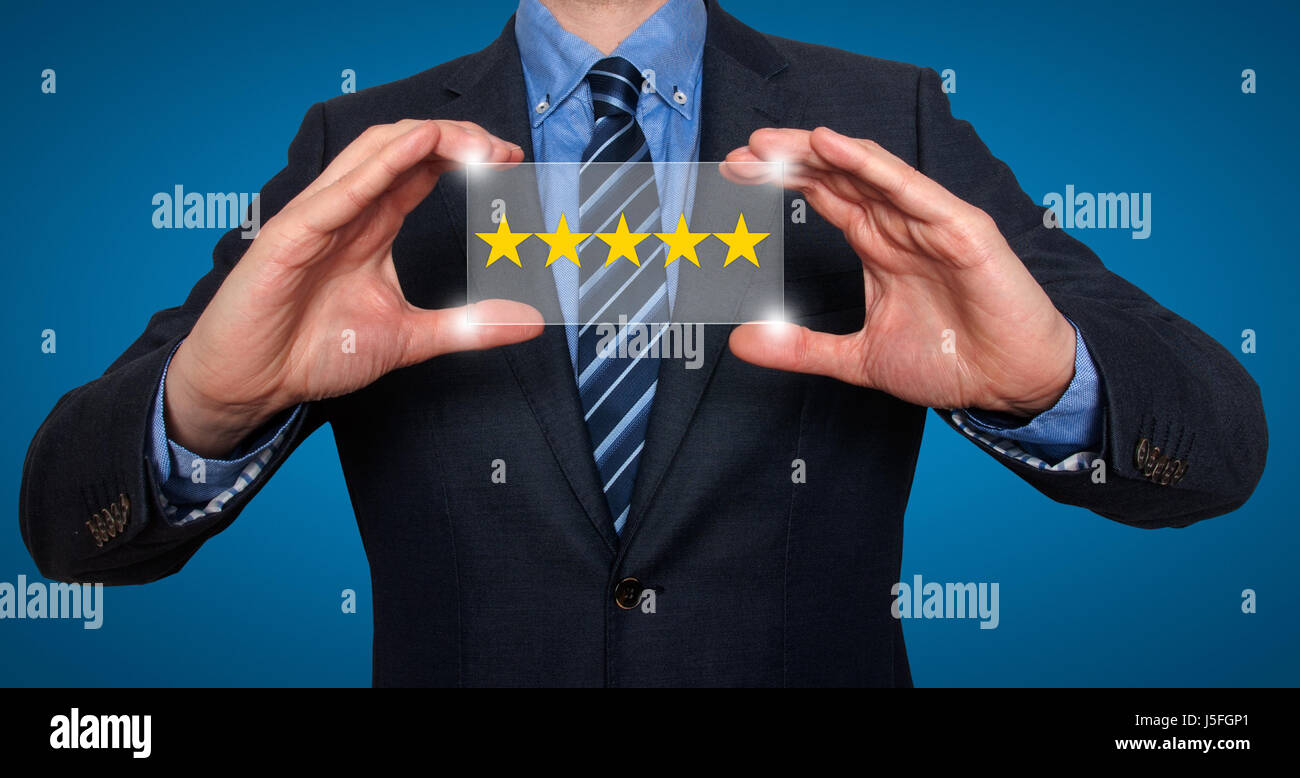 Businessman holding five star rating. Blue - Stock Image Stock Photo ...