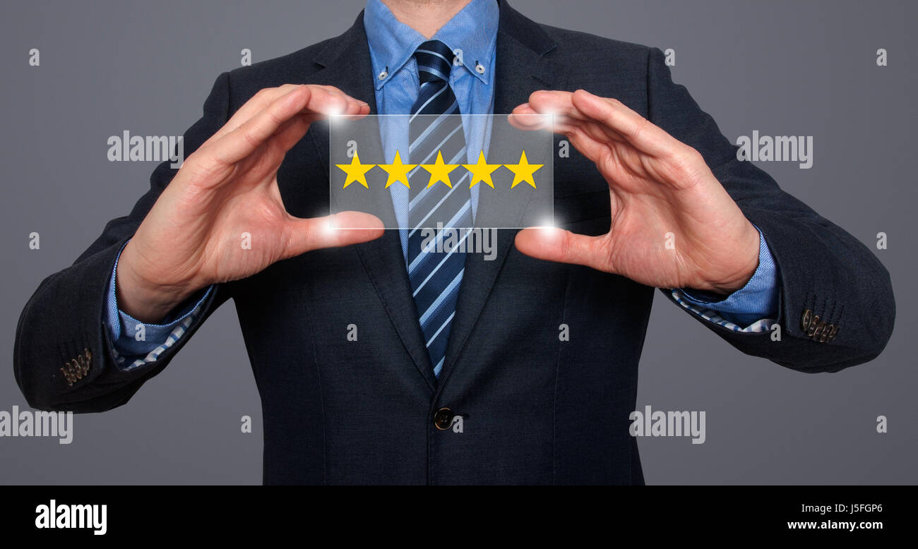 Businessman holding five star rating. Grey - Stock Image Stock Photo ...