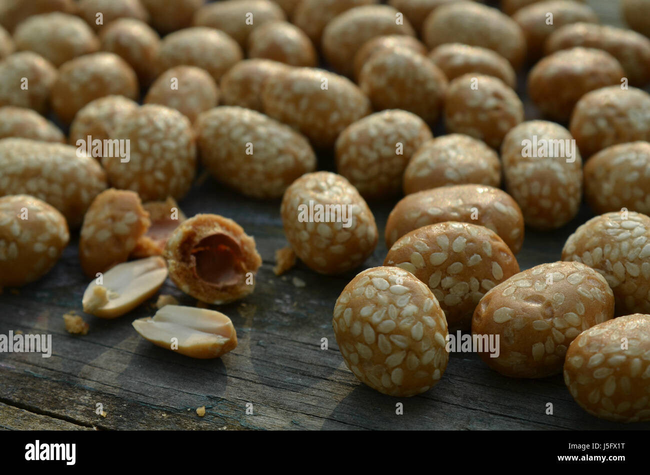 sesame seed covered candied peanuts Stock Photo - Alamy