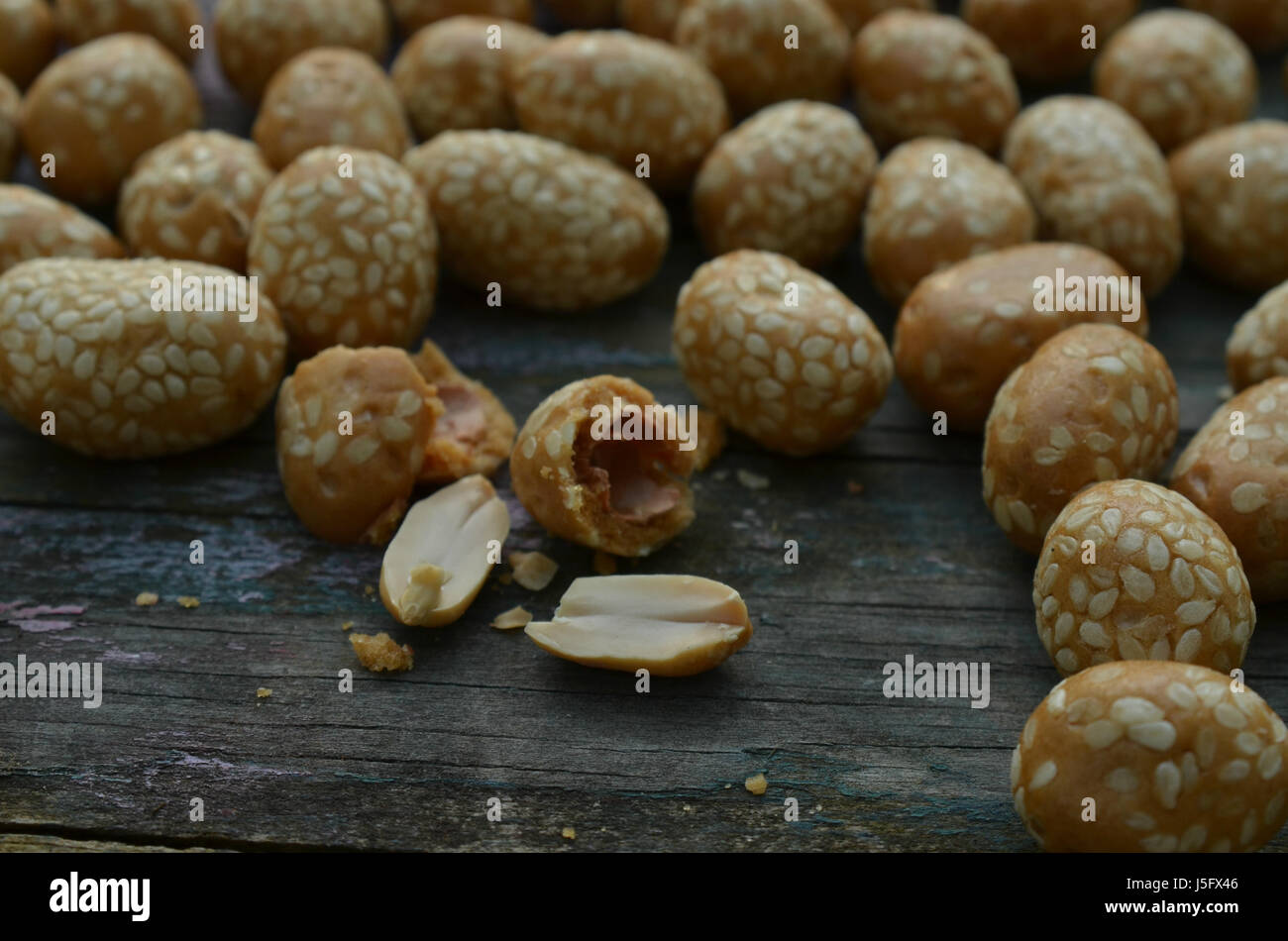 sesame seed covered candied peanuts Stock Photo - Alamy