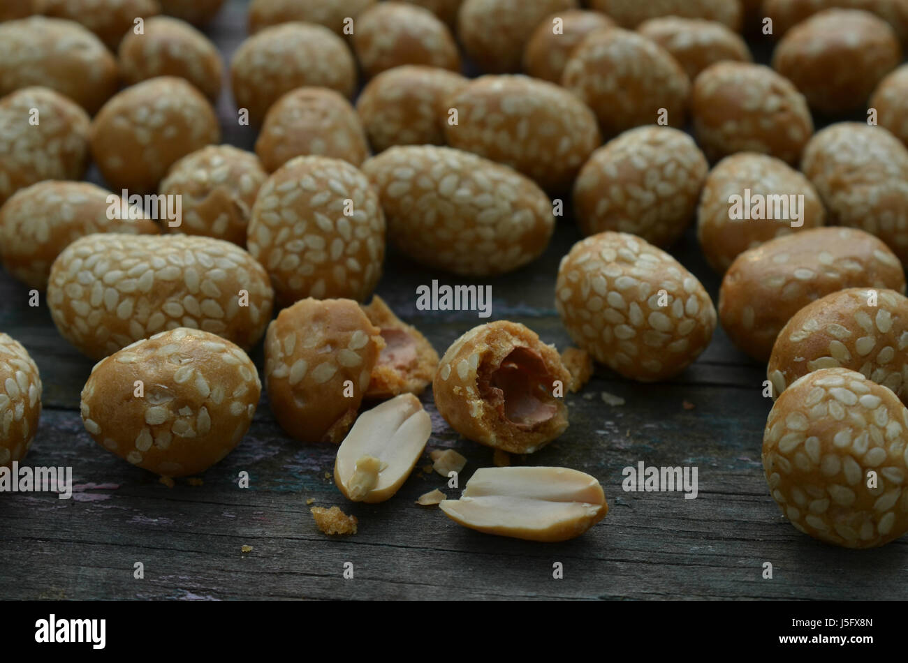 sesame seed covered candied peanuts Stock Photo - Alamy