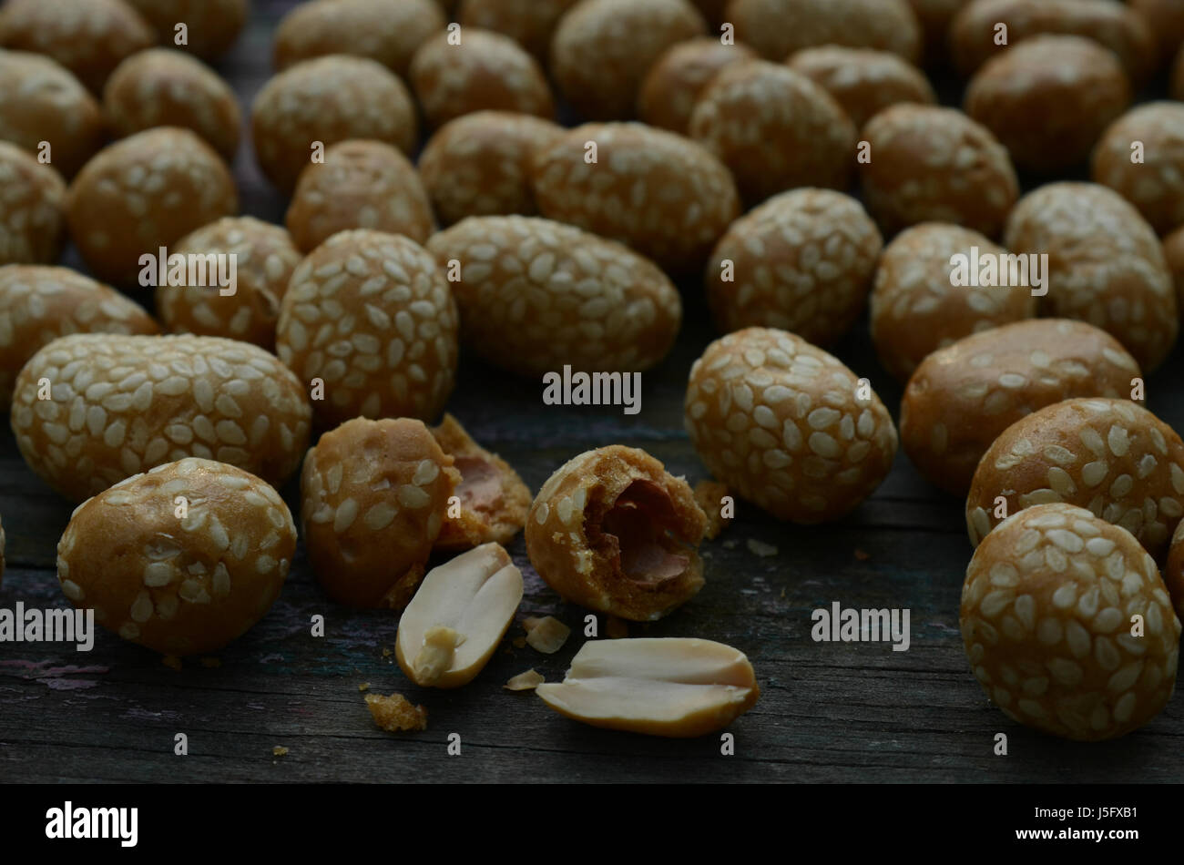sesame seed covered candied peanuts Stock Photo - Alamy