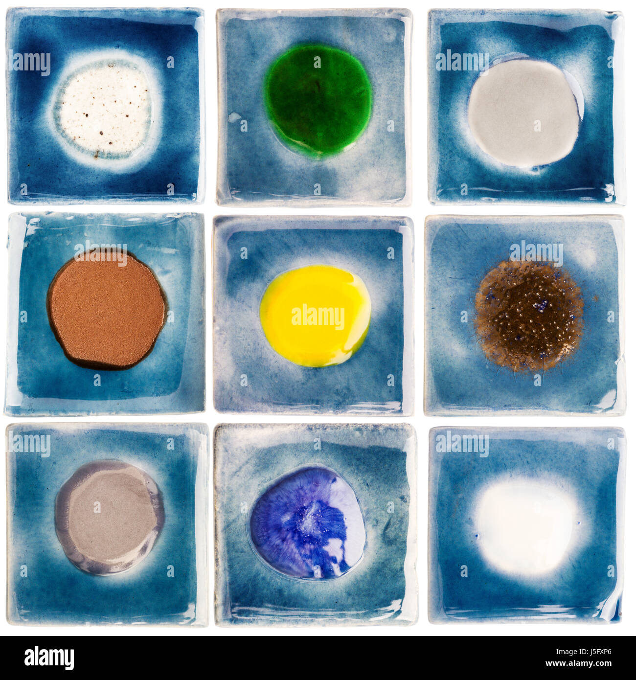 Collection of blue handmade glazed ceramic tiles with other color dots ...