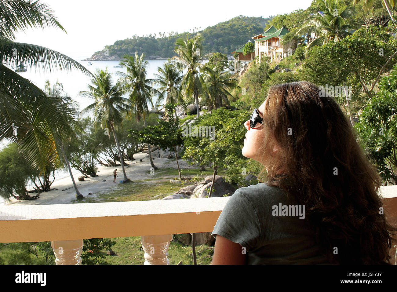 woman on balcony off the beach and palm trees Stock Photo - Alamy