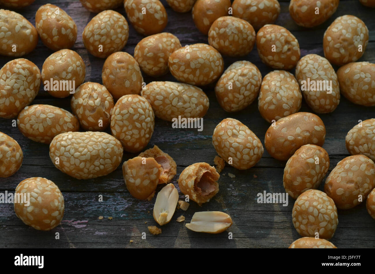 sesame seed covered candied peanuts Stock Photo - Alamy