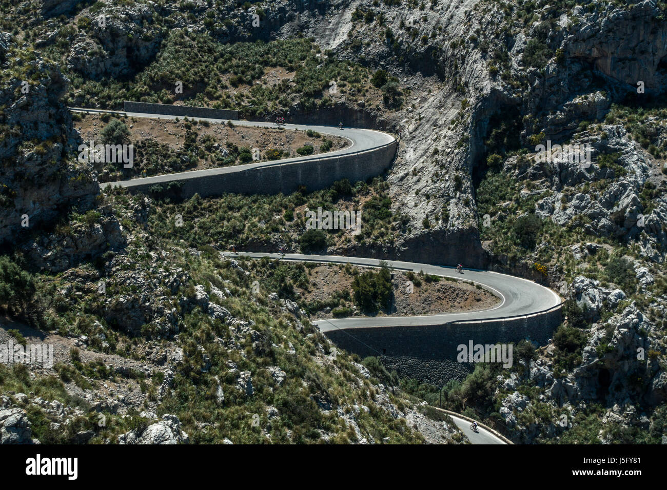 Cyclists on the famous winding road down to the coastal village of Sa ...