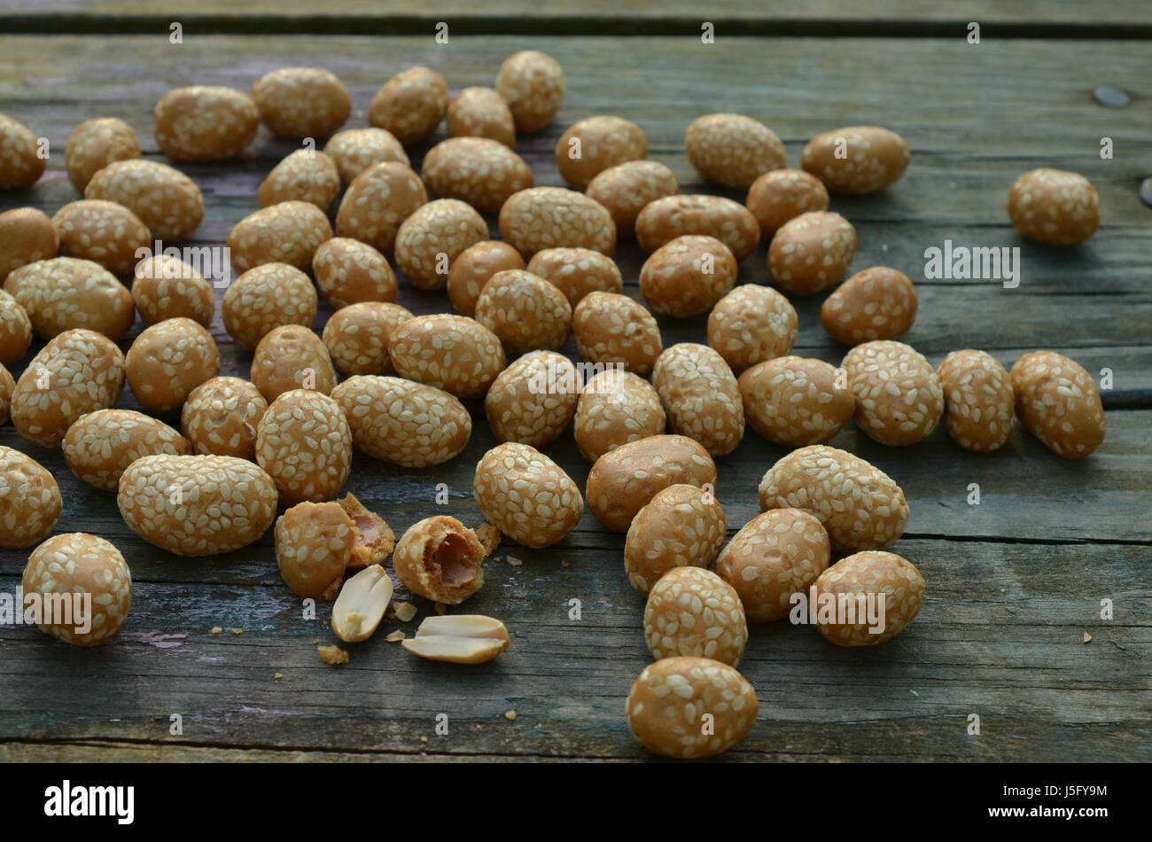sesame seed covered candied peanuts Stock Photo - Alamy