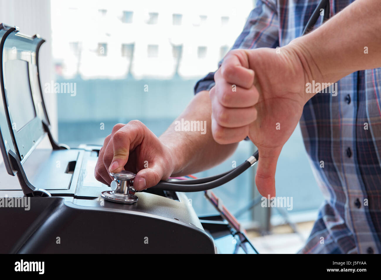 Repairman repairing broken color printer Stock Photo - Alamy