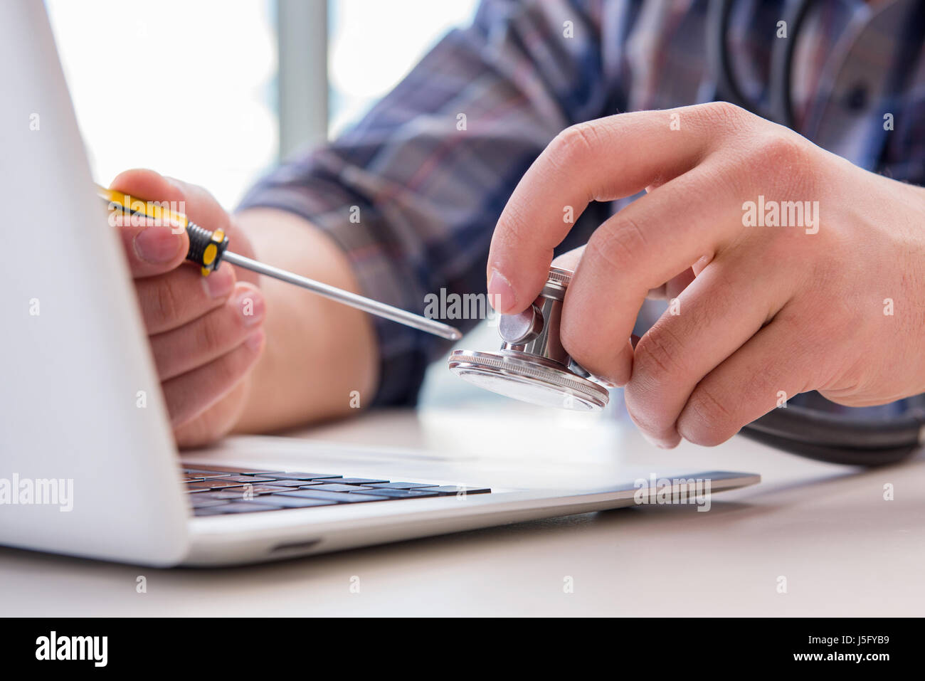 Computer repairman repairing computer laptop Stock Photo - Alamy