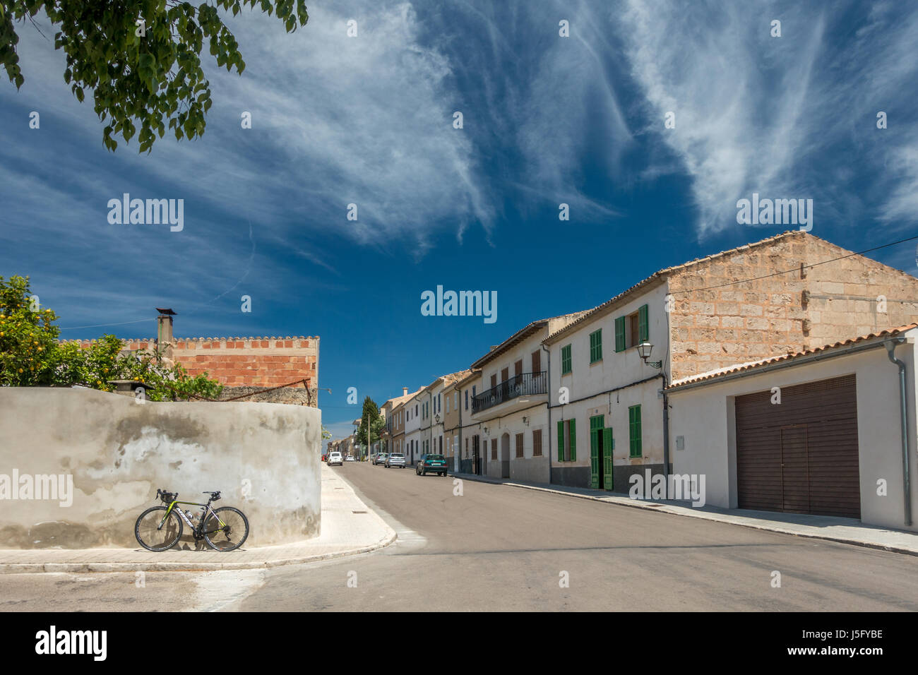 Road bike resting against a wall in the unspoilt and pretty village of ...