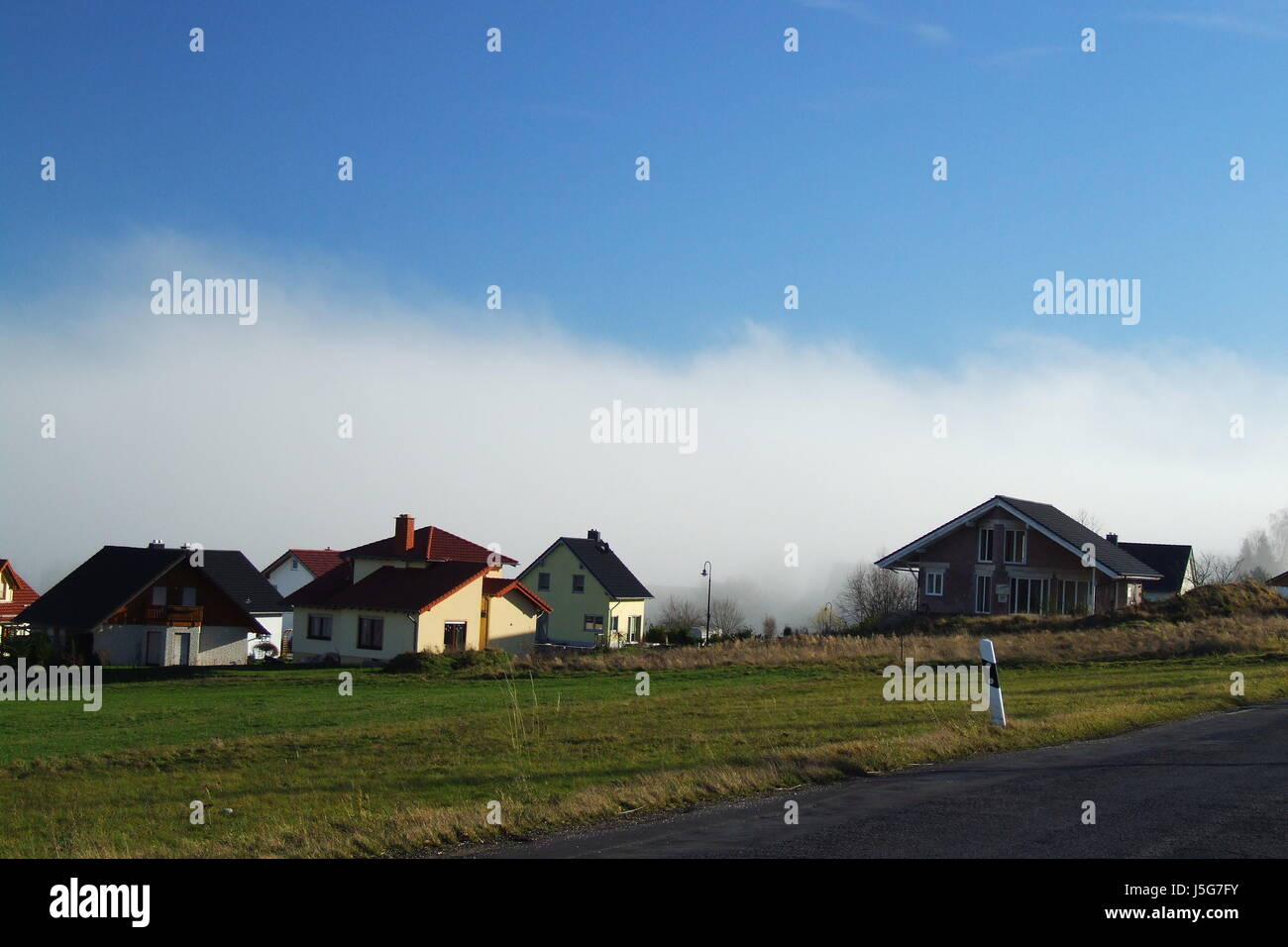 fog behind houses Stock Photo - Alamy