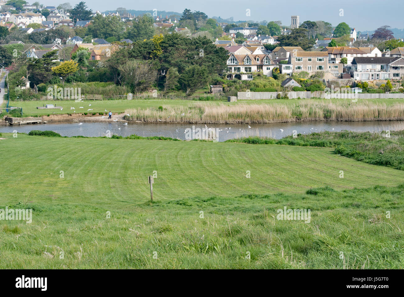 The coastal town of Charmouth, with the River Char in the foreground ...