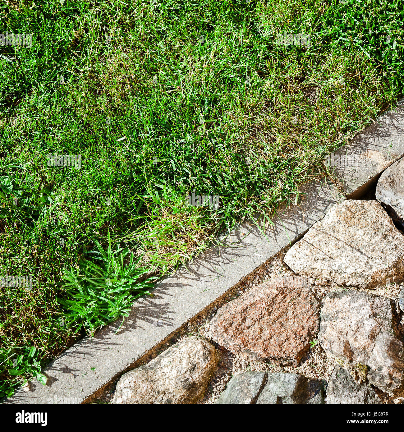 Stone paving and green grass textures background Stock Photo - Alamy